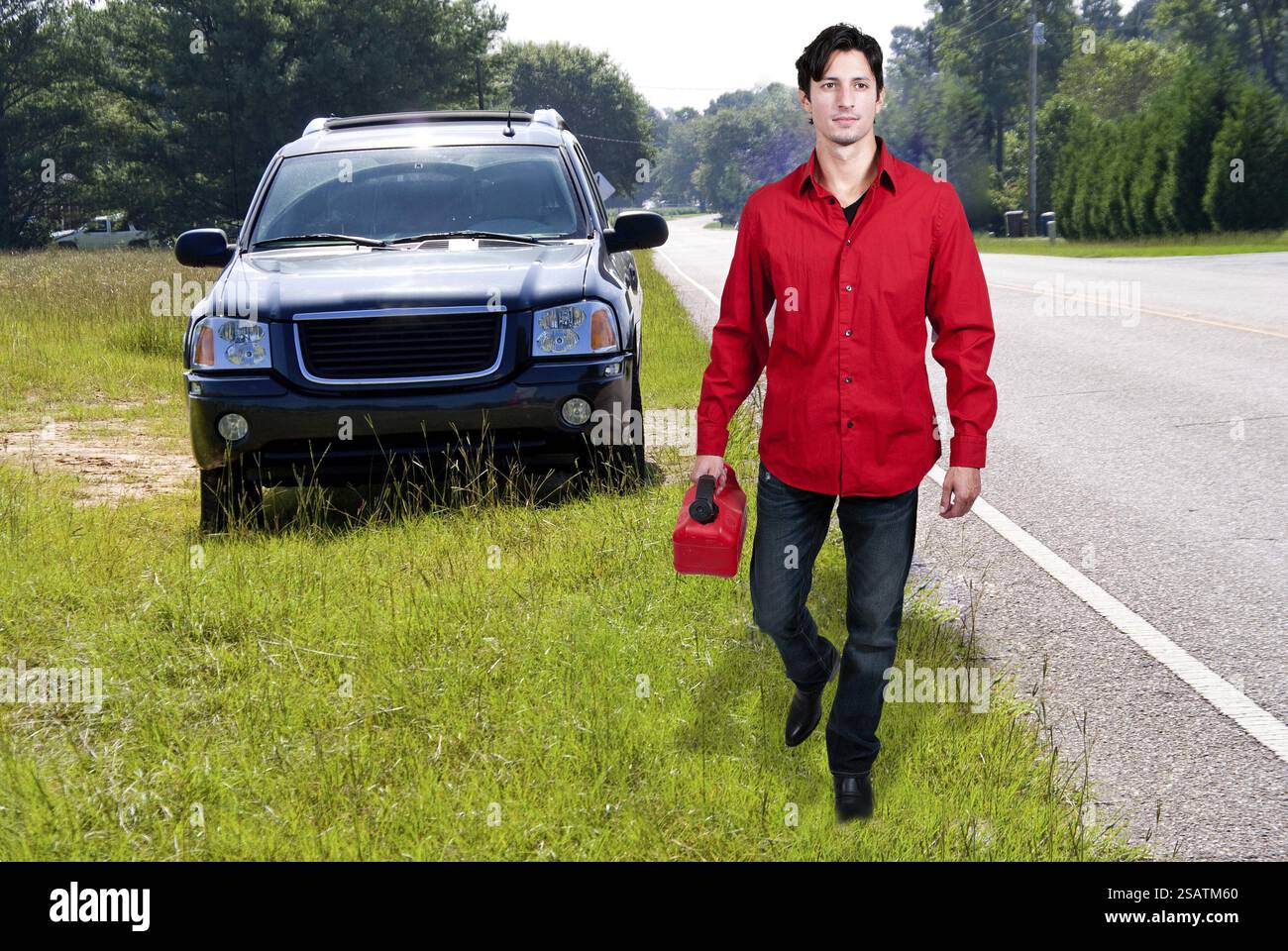 Handsome man with gas can out of gas Stock Photo - Alamy