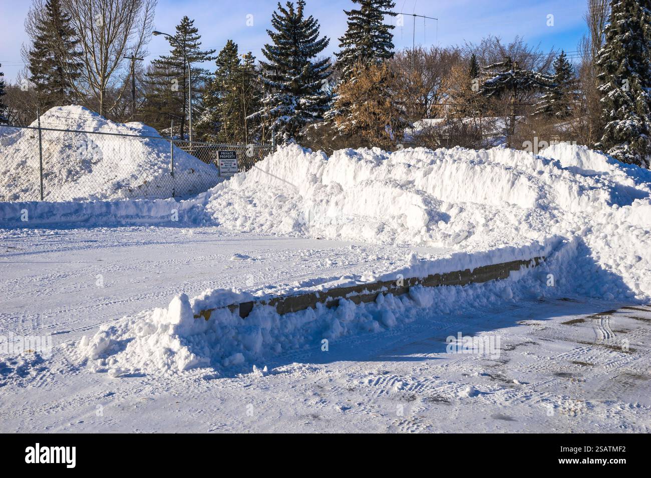Snow piled at private property parking lot Stock Photo - Alamy