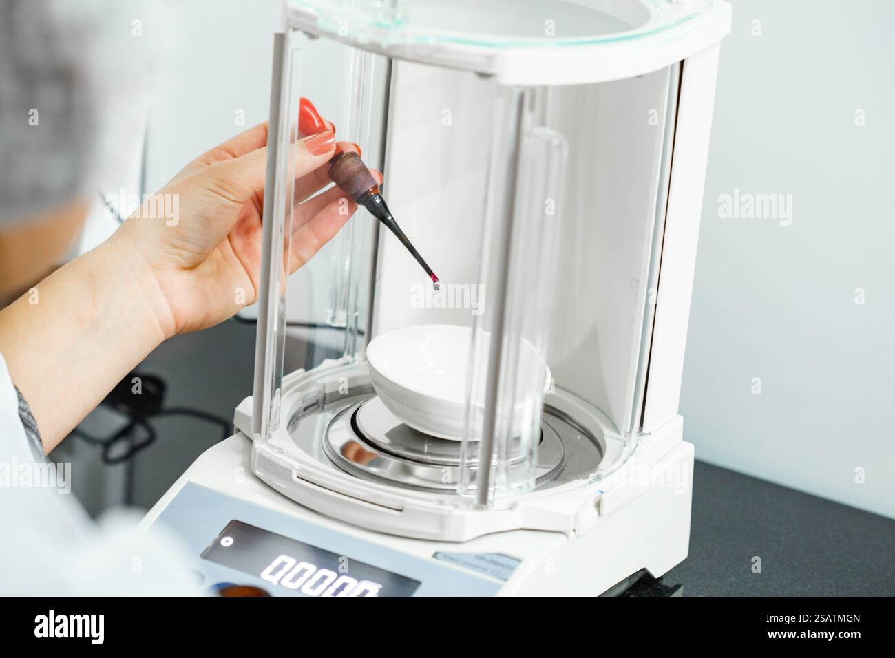 Precision weighing of liquid in a laboratory setup with an analytical ...