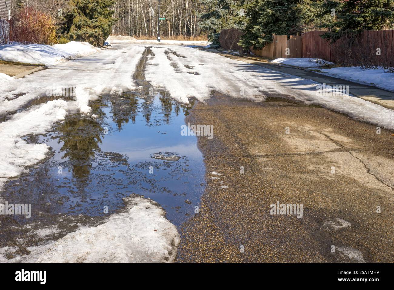 residential street spring snow melt down Stock Photo - Alamy