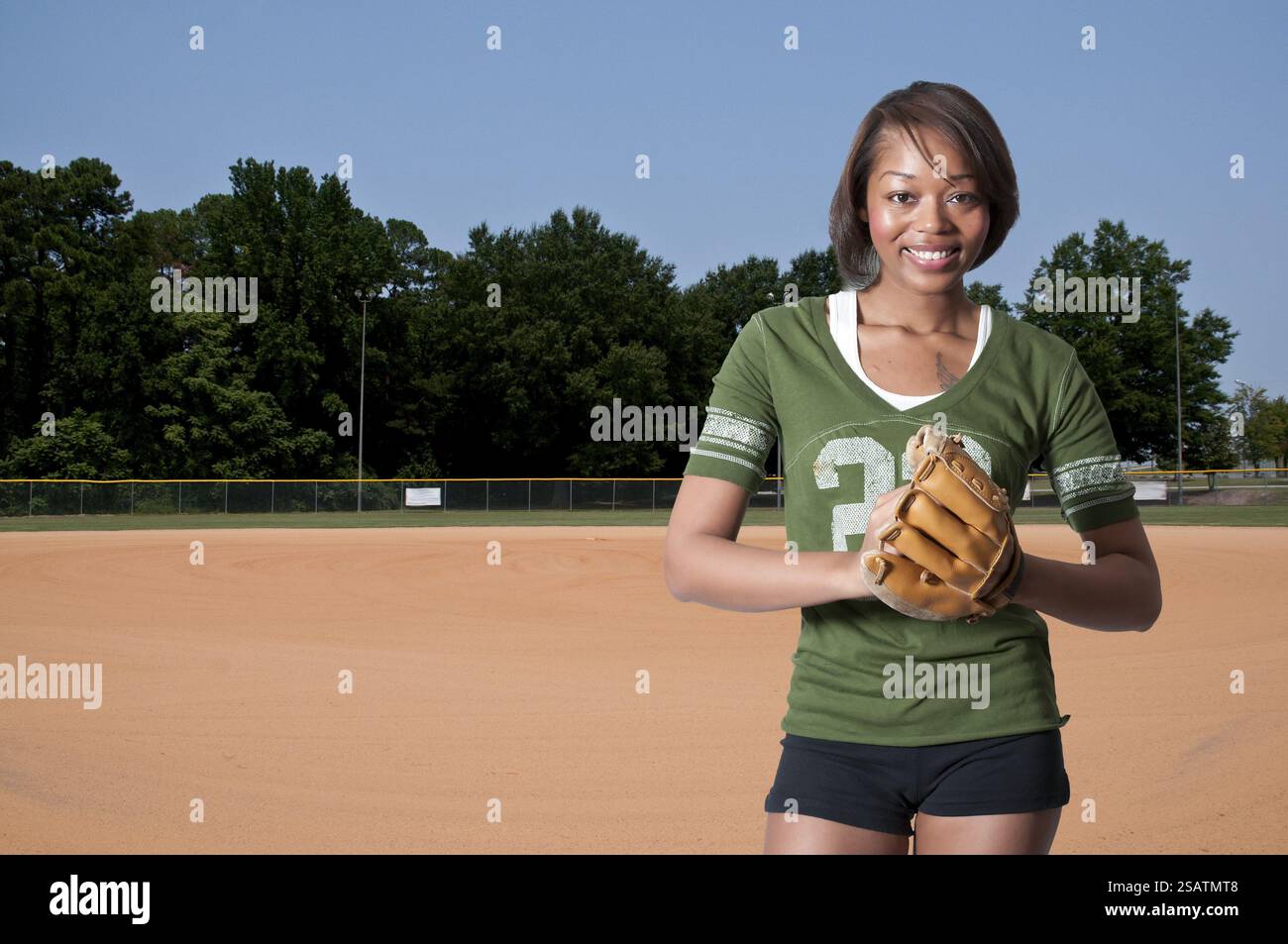 Black African American woman playing baseball at a community park Stock ...