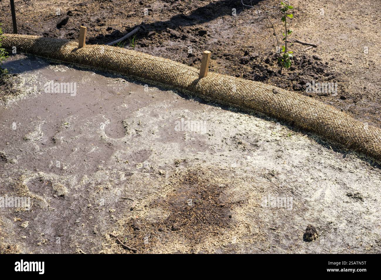 Silt catch by biodegradable erosion control straw sock guard fixed on a ...