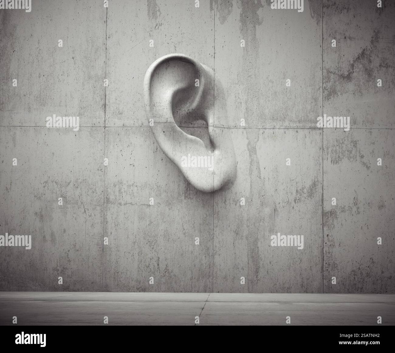 Cement sculpture in the shape of a human ear on a concrete wall. Even ...