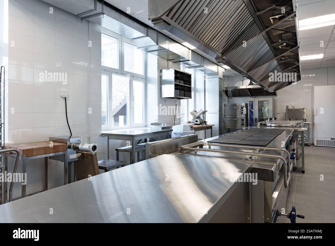 Modern commercial kitchen with stainless steel countertops and ...