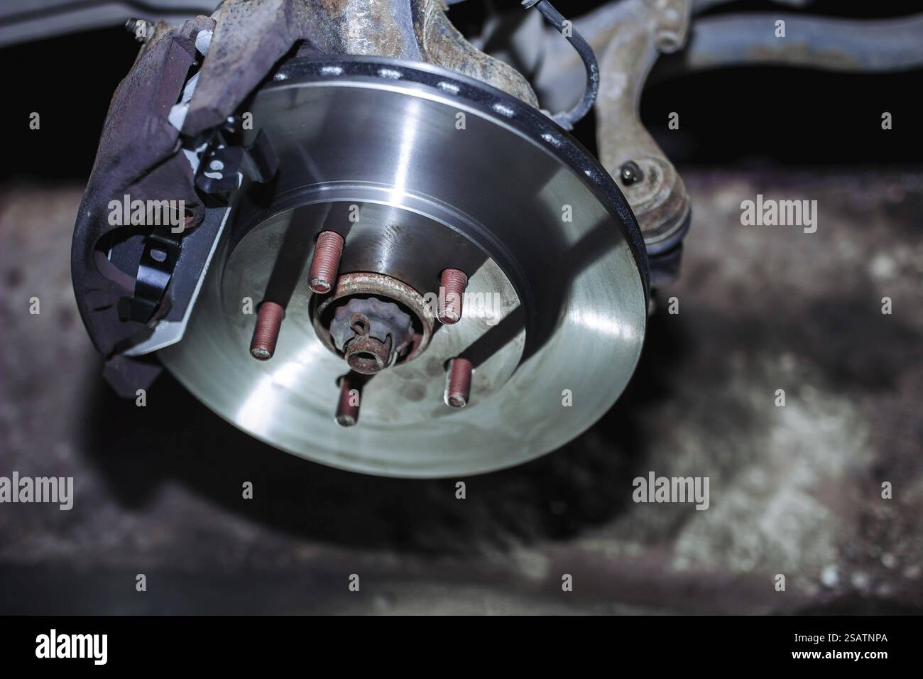A brake rotor attached to a car's suspension during maintenance Stock ...