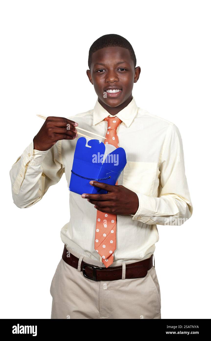 Handsome teenage black African American man eating Chinese Japanese or ...
