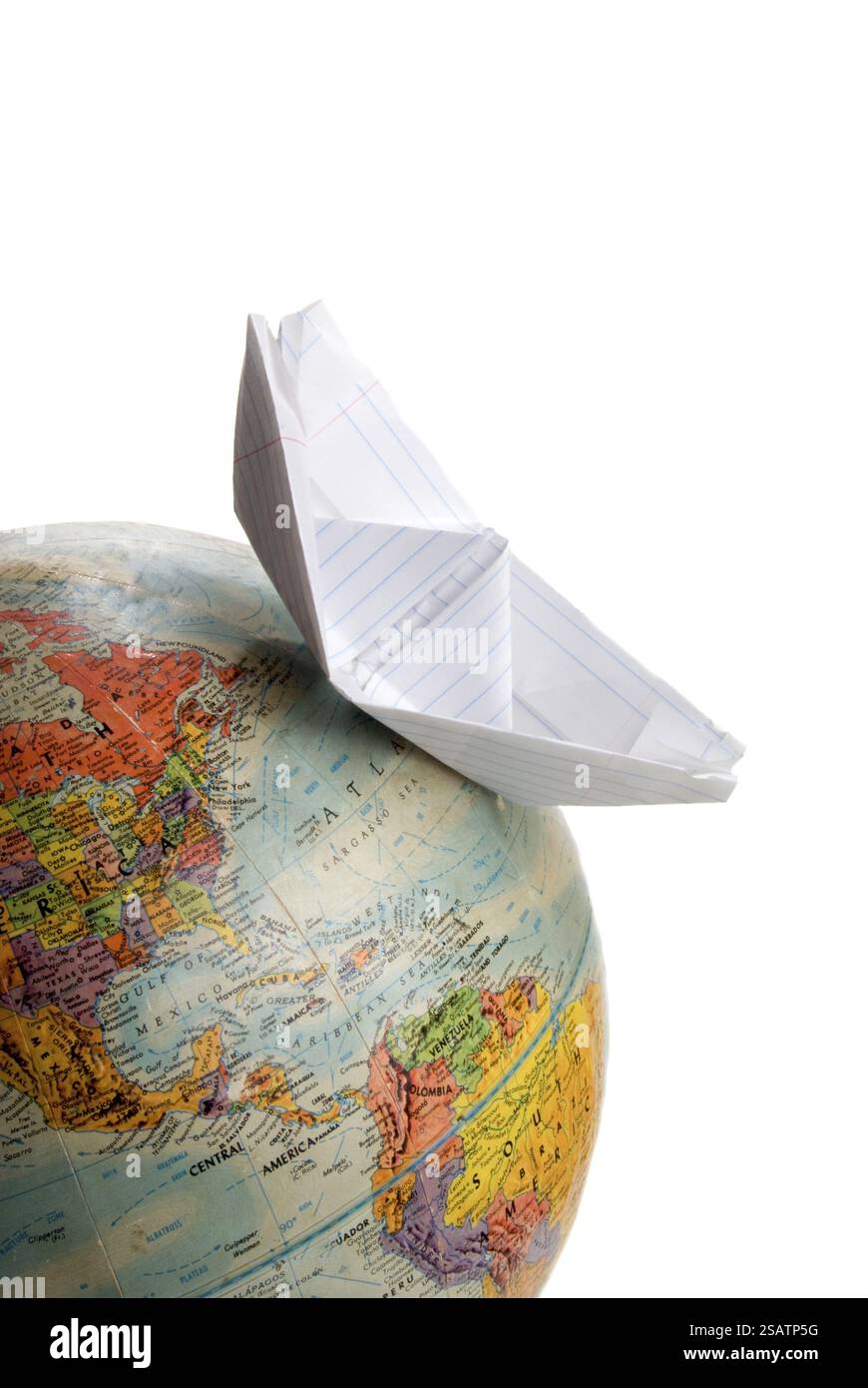 A boat sailing across a globe of the world Stock Photo - Alamy