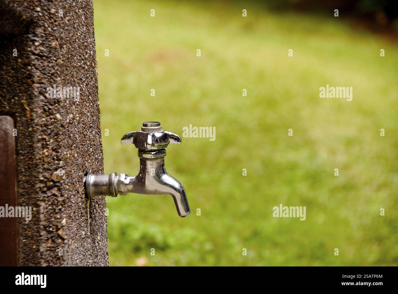 A outdoor spigot ready to spit out water Stock Photo - Alamy