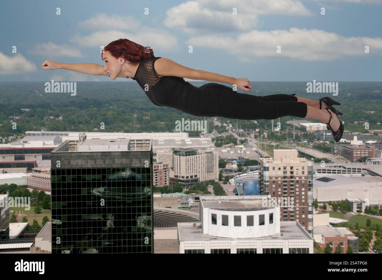 Beautiful young woman flying or falling through the air Stock Photo - Alamy