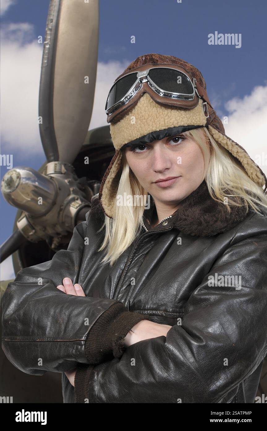 Woman pilot wearing vintage pilot helmet flight jacket and goggles ...