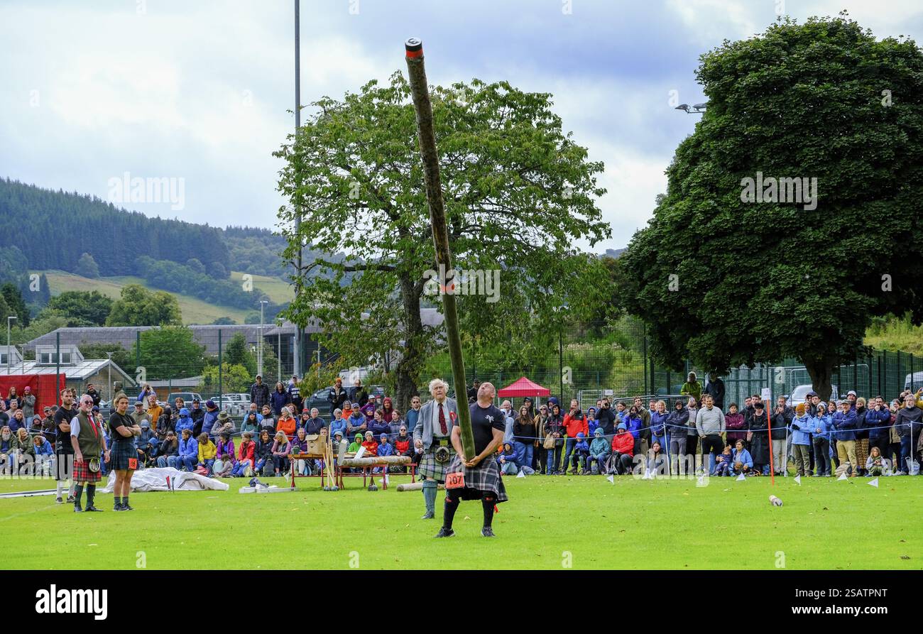 Log throwing at the traditional Glen Urquhart Highland Games, Scotland ...