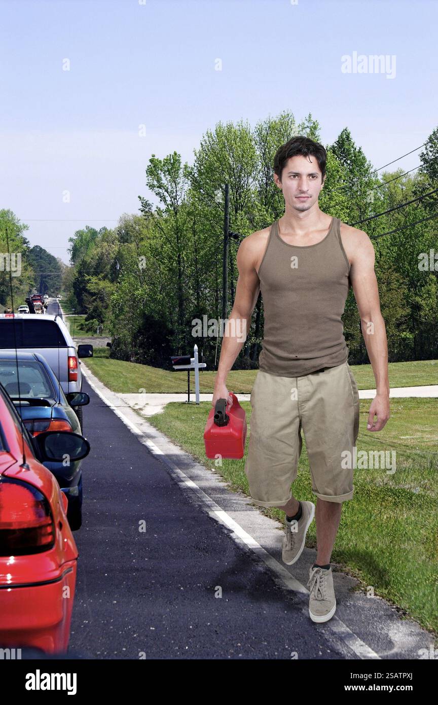 Handsome man with gas can out of gas Stock Photo - Alamy