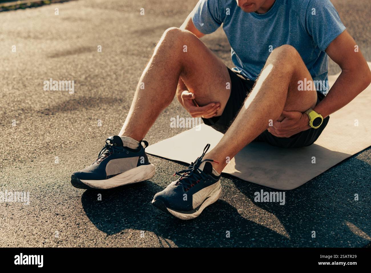 Runner experiencing muscle strain during exercise on a matte surface in ...