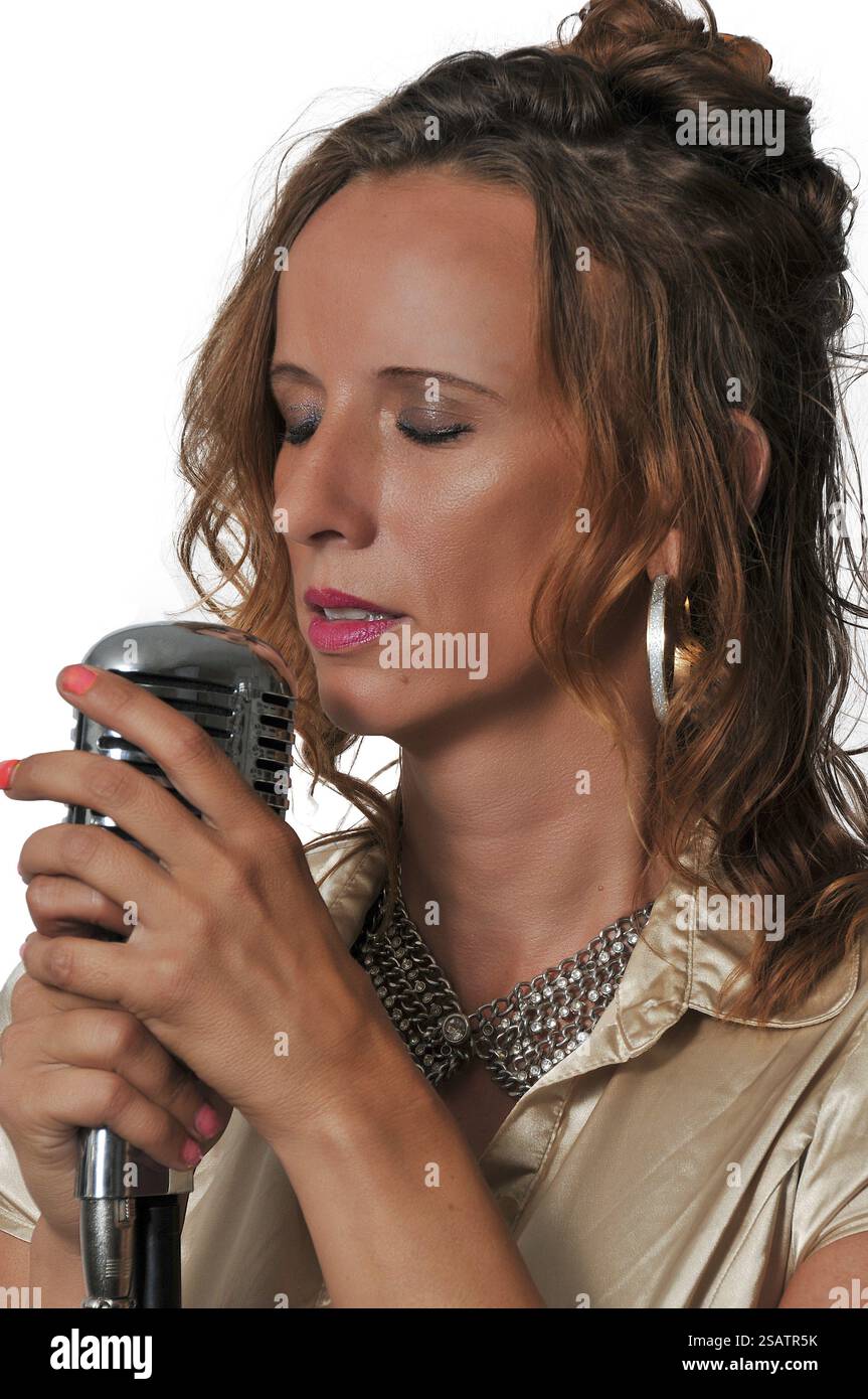 Beautiful woman singer performing with a vintage microphone Stock Photo ...