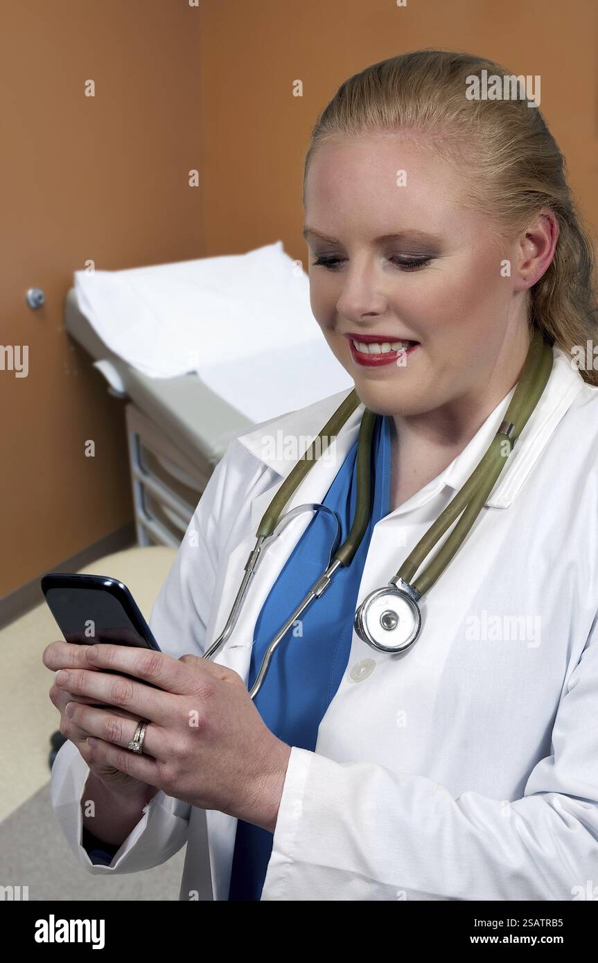 Woman medical doctor using a cell phone to text Stock Photo - Alamy
