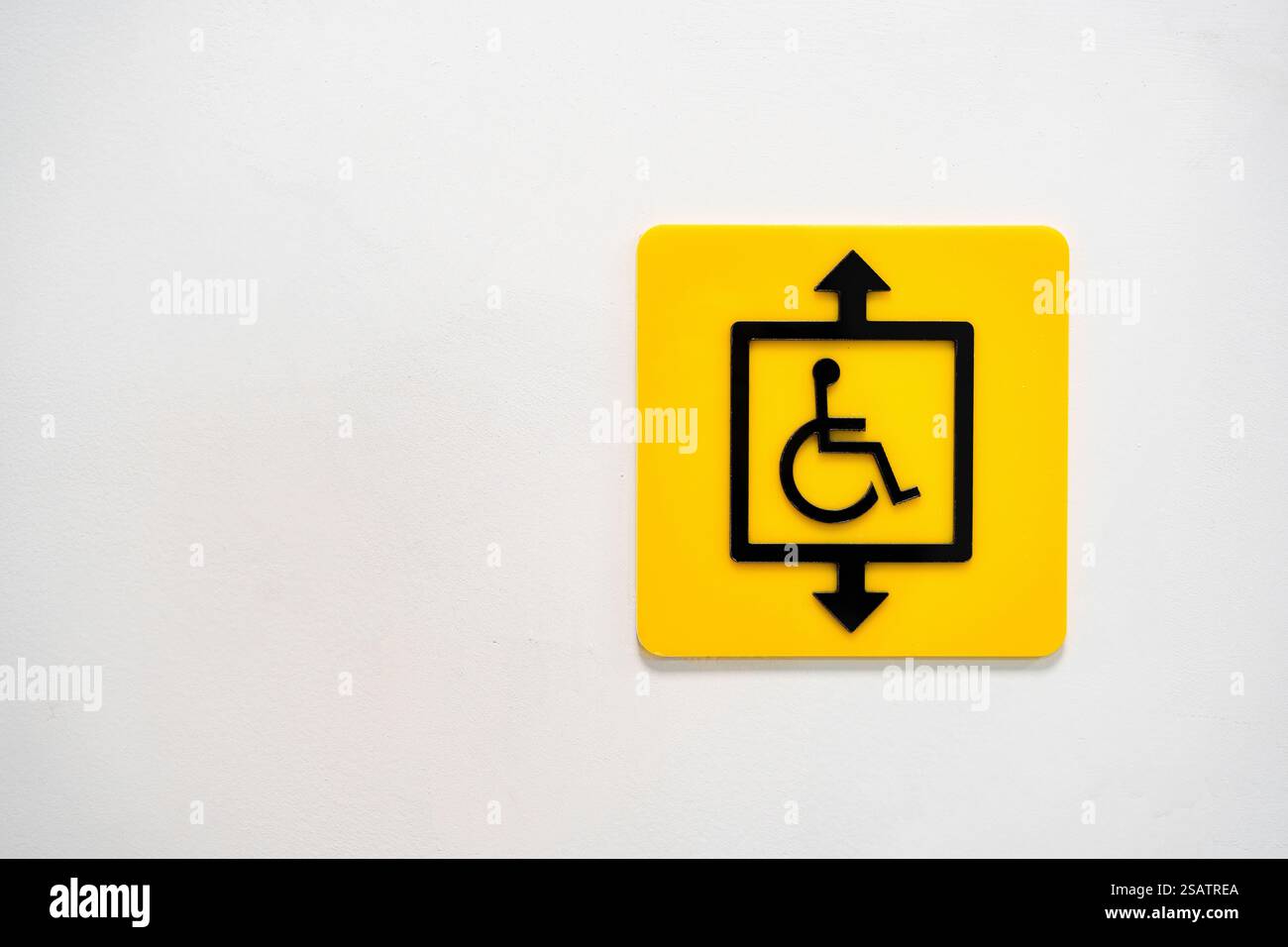 Sign indicating an accessible elevator for individuals with ...