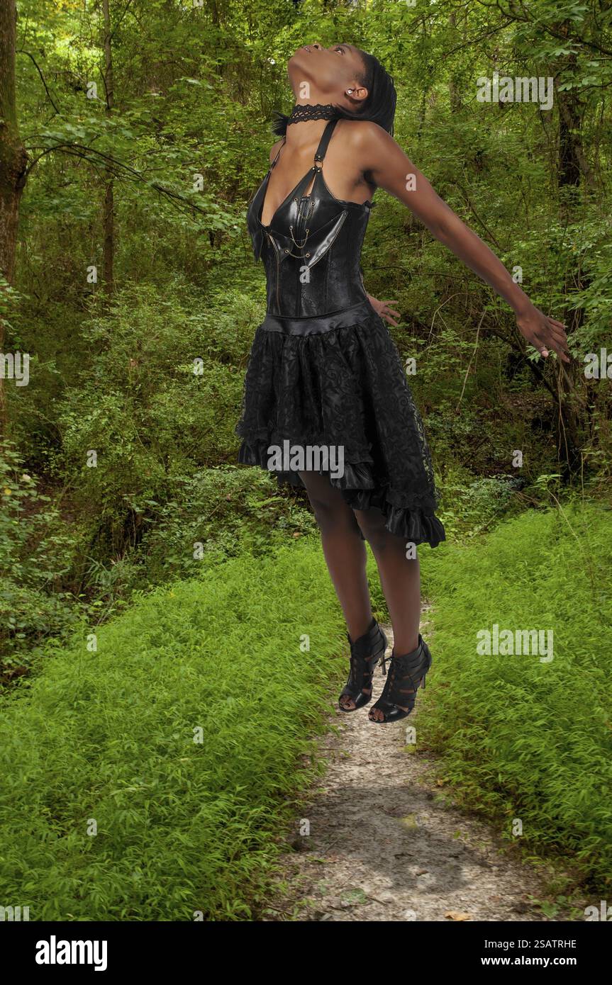 Beautiful young black woman floating in the air Stock Photo - Alamy