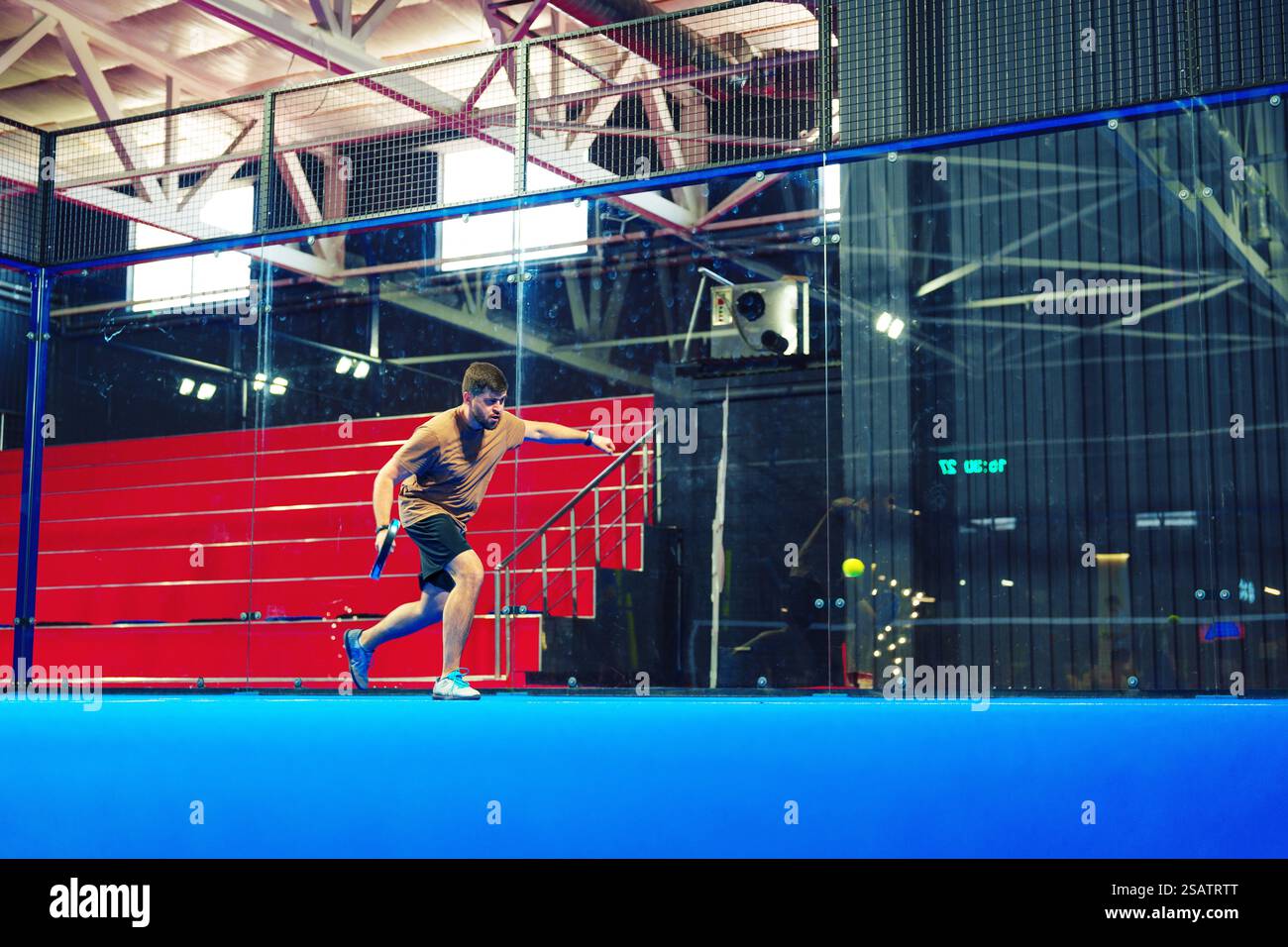 Intense indoor squash player showcases skills during a competitive ...