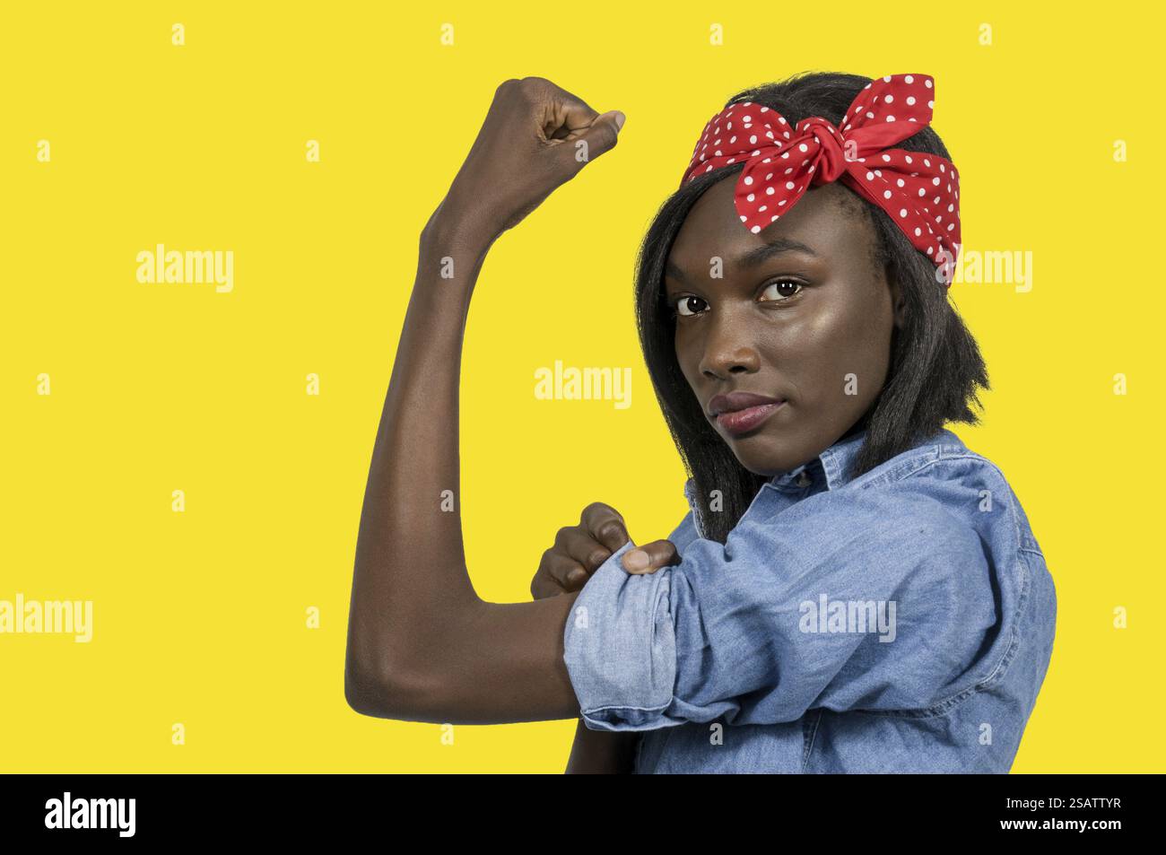 Beautiful woman dressed as the iconic Rosie the Riveter Stock Photo - Alamy