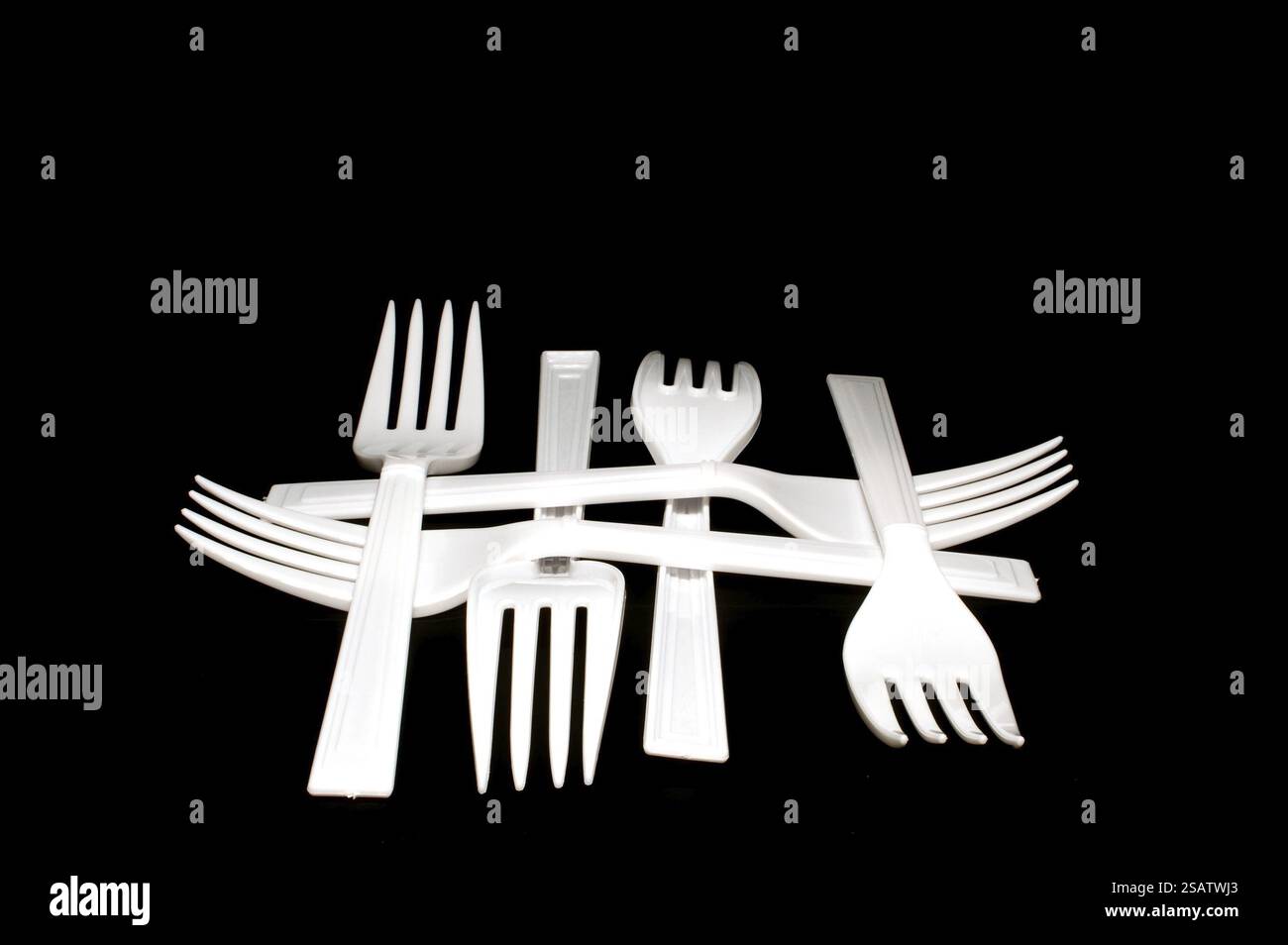 A collection of plastic forks in a pattern Stock Photo - Alamy