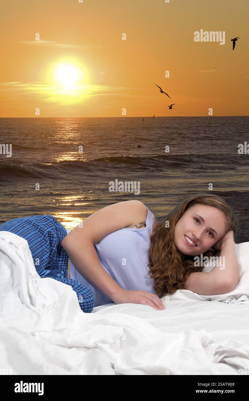 Beautiful young woman in bed at bedtime Stock Photo - Alamy