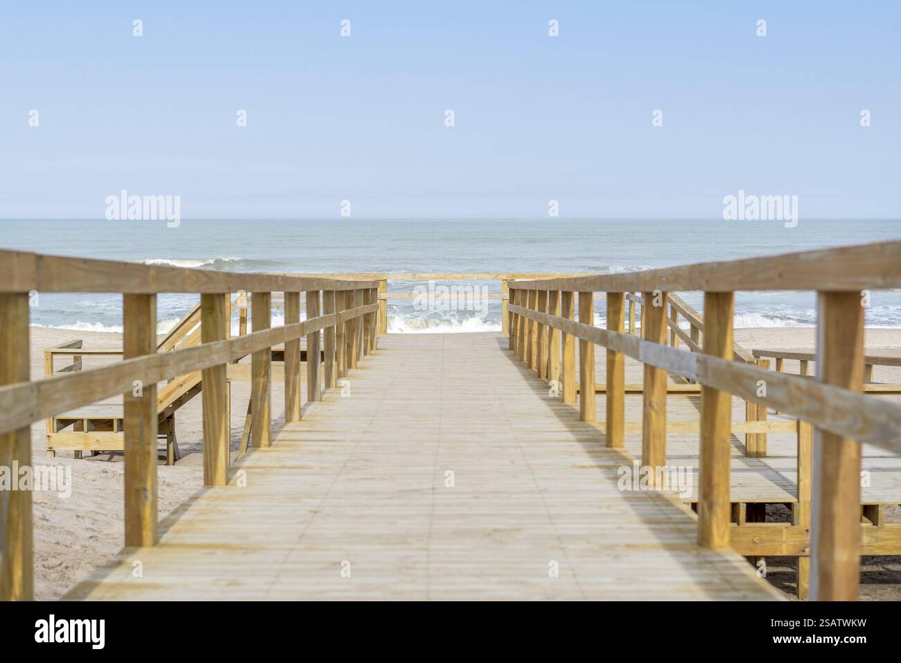 Scenic wooden walkway inviting visitors to a bright beach paradise ...
