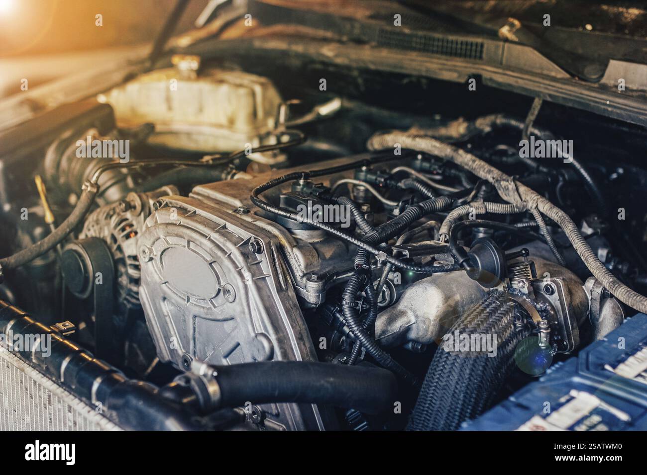 Car engine and machinery parts seen in sunlight, depicting interior ...