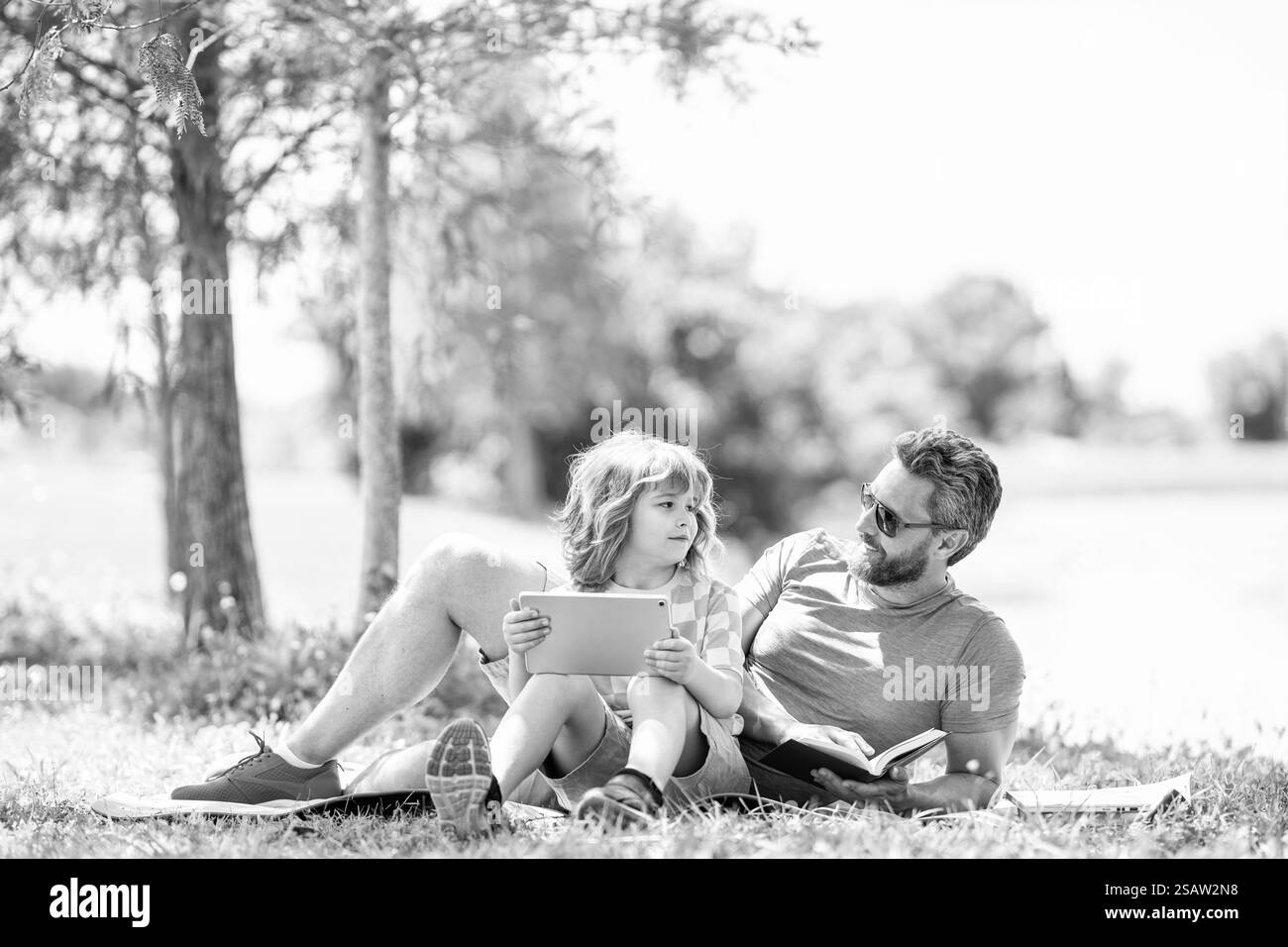 Father shapes son education. Father and son child relax in park ...