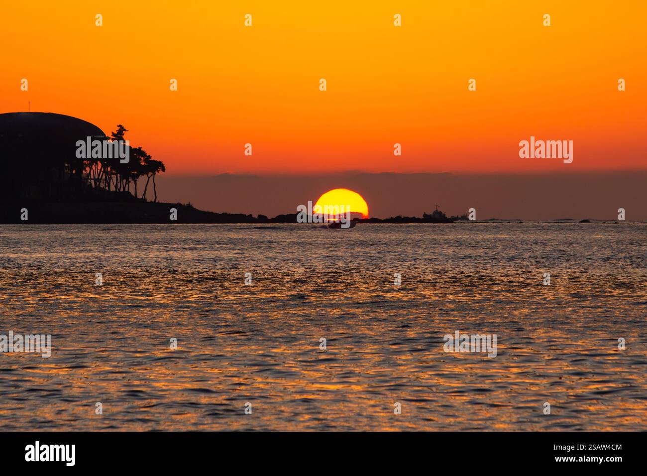 The sea and fishing boats with the red sun rising Stock Photo - Alamy