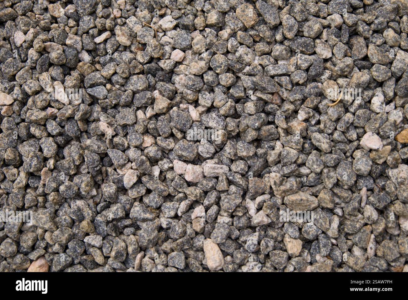 A close-up photograph of a gravel texture, showcasing the varied shapes ...