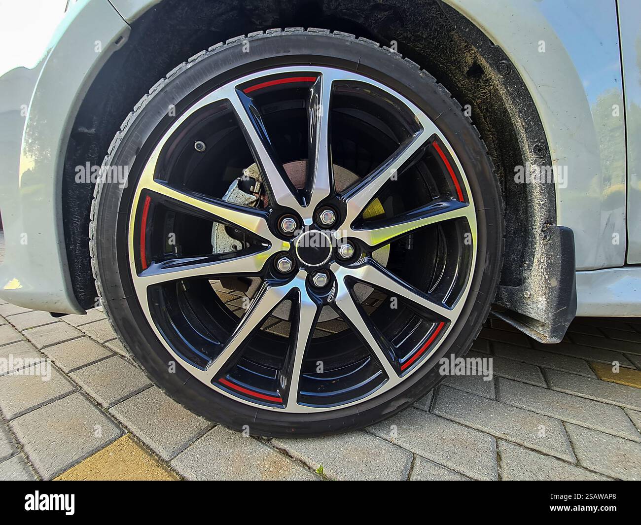 Stylish sport car wheel, highlighting the design of the rim and tire on ...