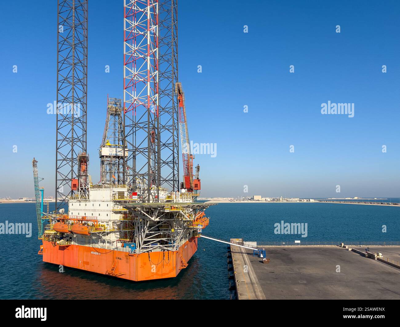 Manama, Bahrain - January 5, 2025: An offshore oil rig docked at a port ...