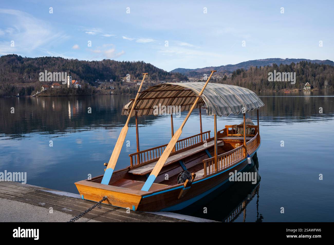 Rowing Boat at beautiful Bled lake and Bled castle on the clift. It is ...