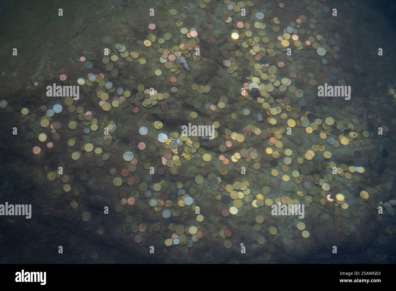 Lots of coins thrown for luck, laying on the bottom of water in ...