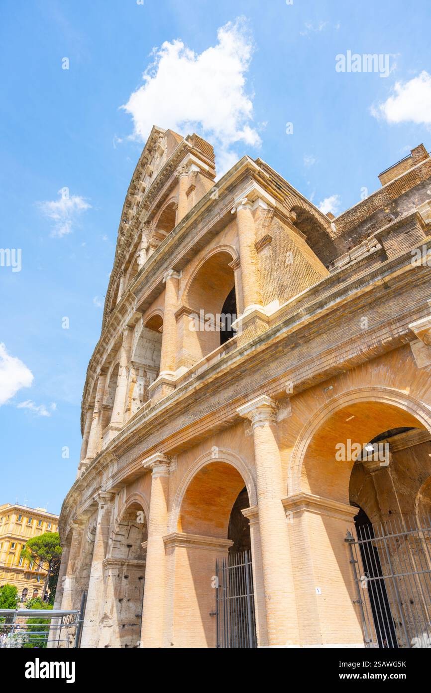 The iconic Colosseum in Rome stands tall against a bright blue sky ...