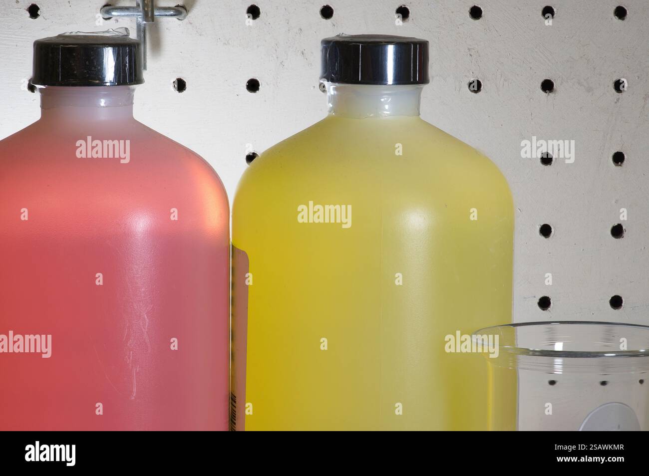 Two plastic bottles in a testing lab with pink and yellow liquid Stock ...
