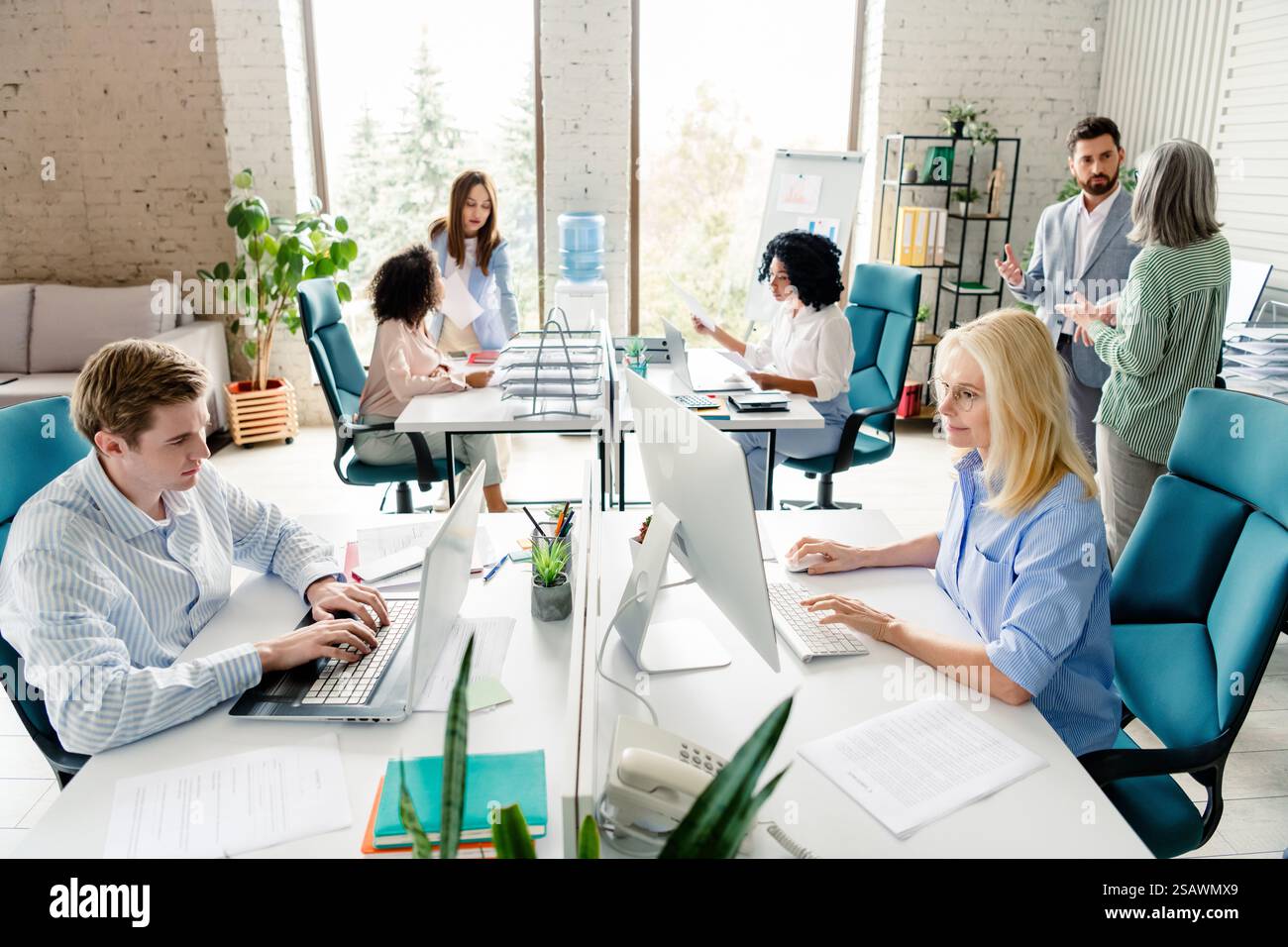 Modern workspace with teams collaborating in a professional and ...