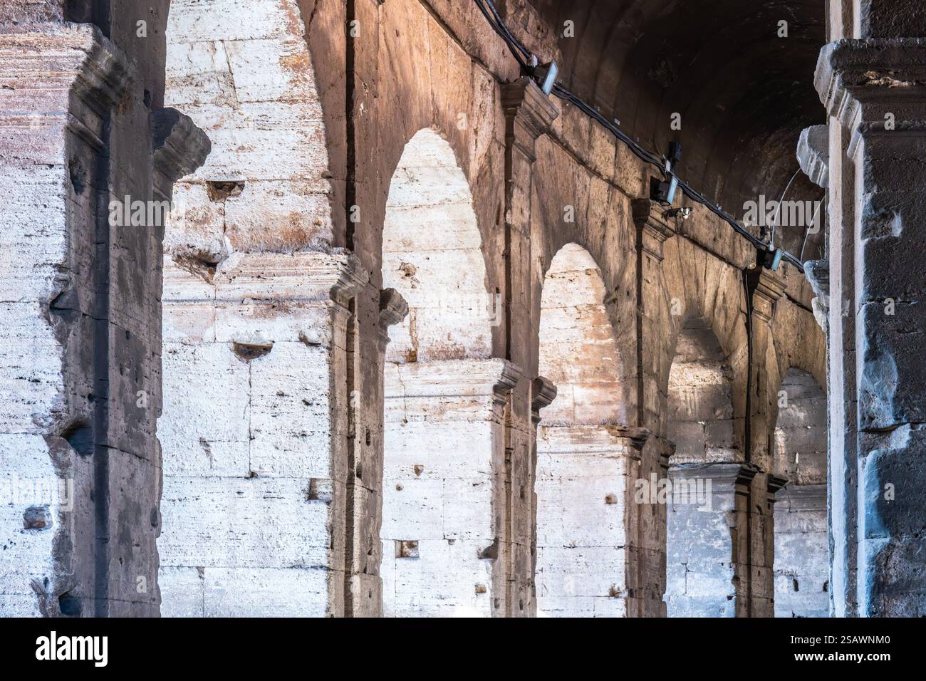 The interior of the Colosseum reveals impressive arches and stonework ...