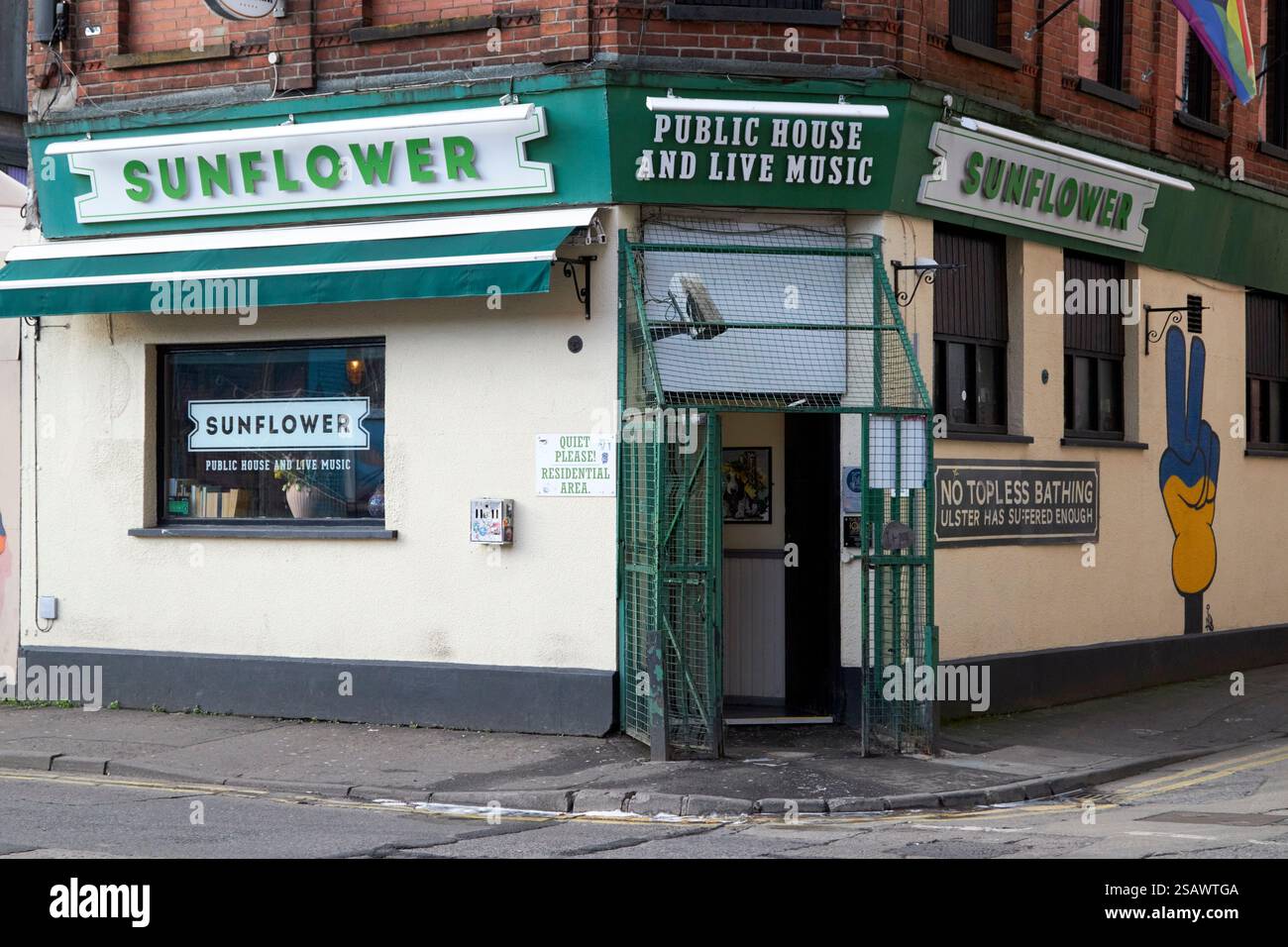 the sunflower public house corner pub with old security gate still ...