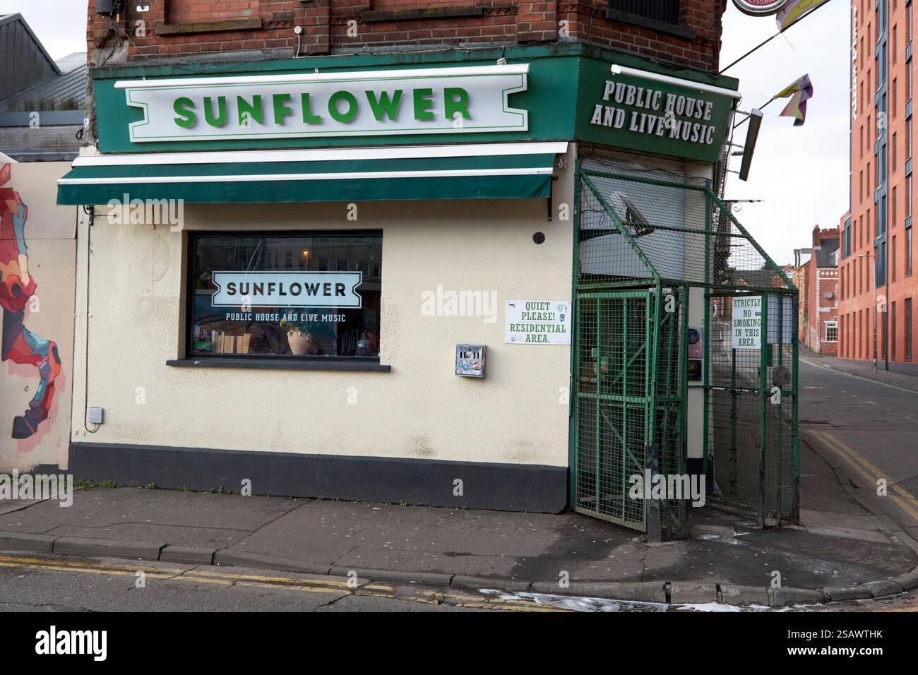 the sunflower public house corner pub with old security gate still ...