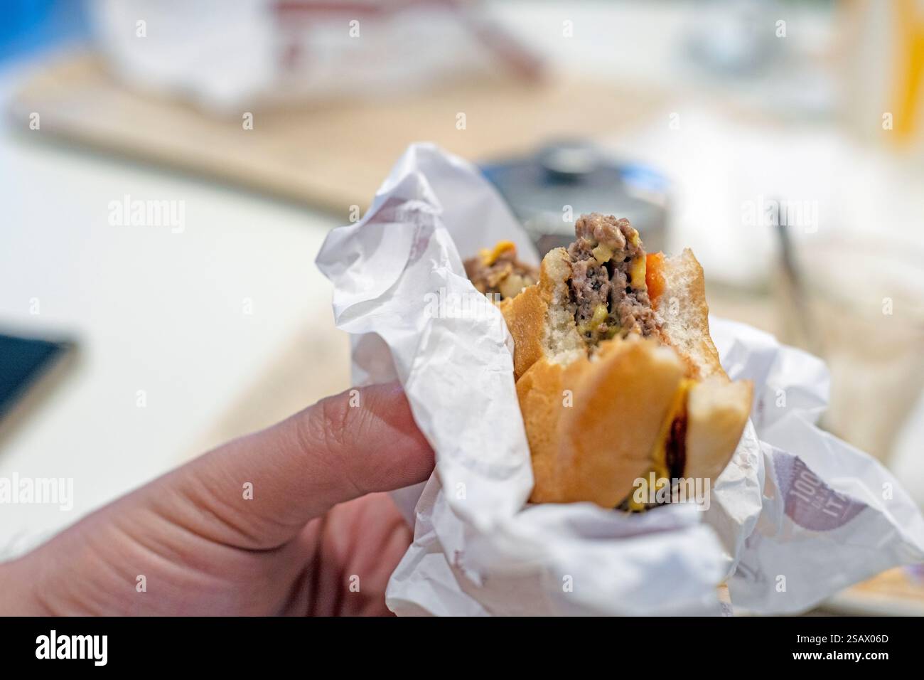 finishing a huge hamburger. Fast food Stock Photo - Alamy