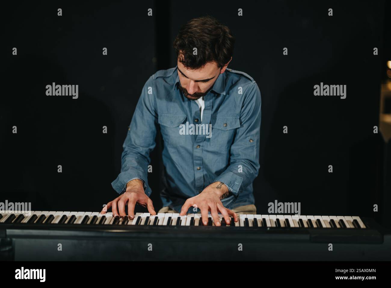 Man Playing Electric Keyboard in a Studio Environment Stock Photo - Alamy