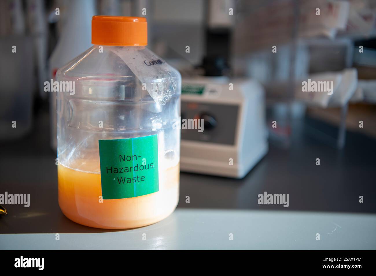 Non-hazardous waste orange liquid gallon plastic jug science lab Stock ...