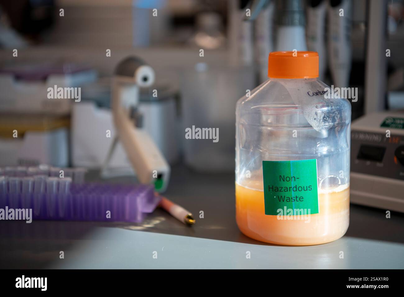 Non-hazardous waste orange liquid gallon plastic jug science lab Stock ...