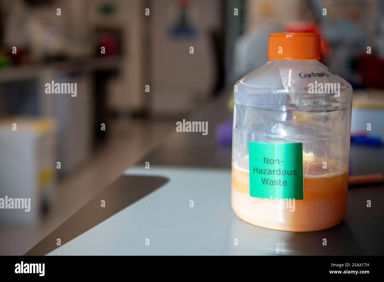 Non-hazardous waste orange liquid gallon plastic jug science lab Stock ...