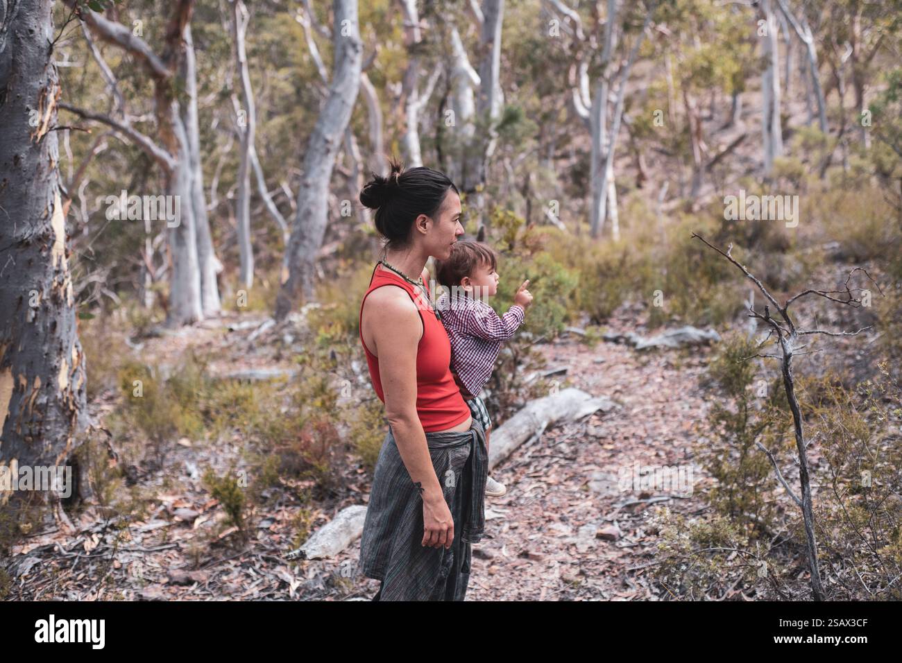 queer mother and child explore nature and point at birds Stock Photo ...
