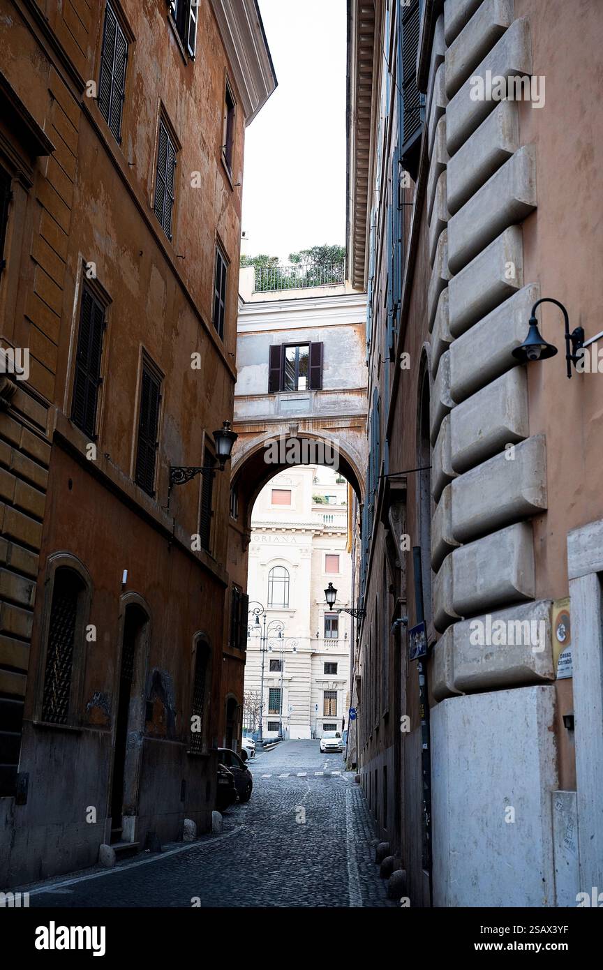 A narrow cobblestone alley in Rome with an arched passageway Stock ...