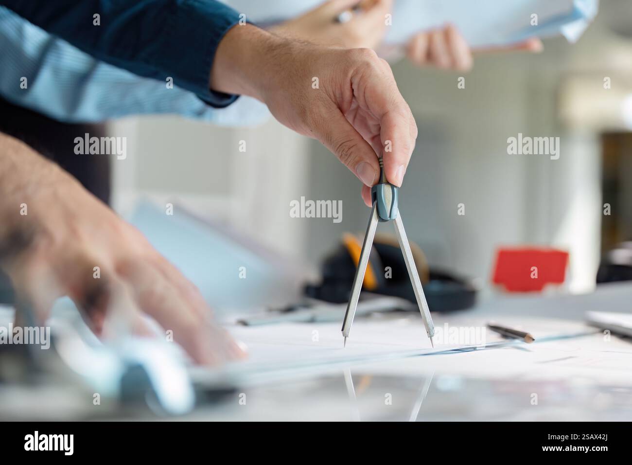 Architect using compass to design plans on a workspace table Stock ...