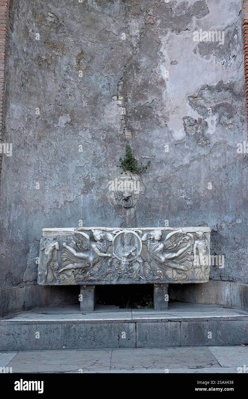An ornate weathered stone fountain with carved mythological figures Stock Photo - Alamy