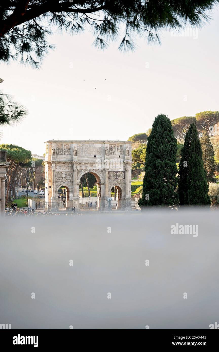 The Arch of Constantine in Rome framed by trees and soft light Stock ...